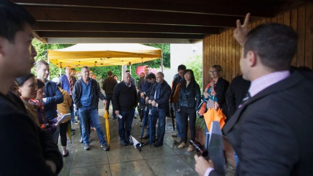 Hordes of buyers defy Sydney storms to bid on homes